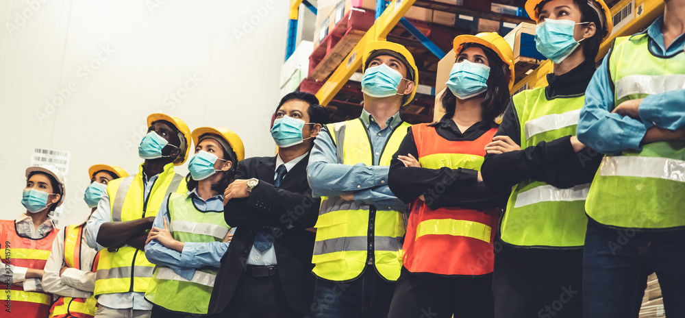 Group of factory industry worker working with face mask to prevent ...