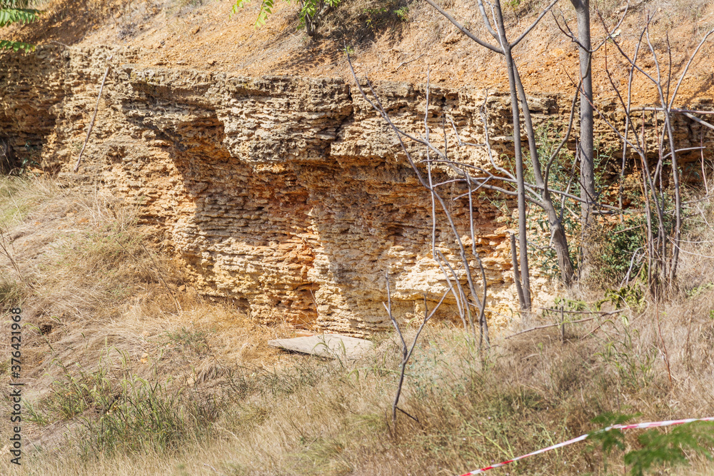 Sedimentary sand and rocks at the site of the landslide. a sandy rocky ...