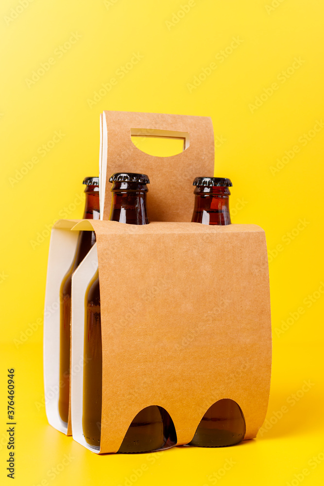 Presentation of pack of four beers with yellow background Stock Photo ...