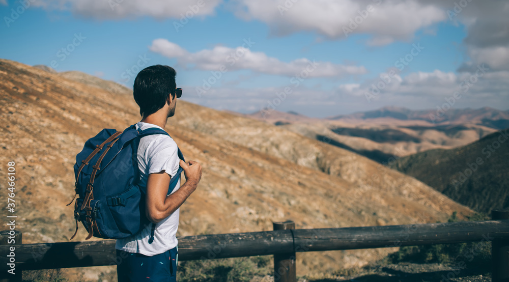 Male wanderer exploring wild land with high altitude in mountains ...