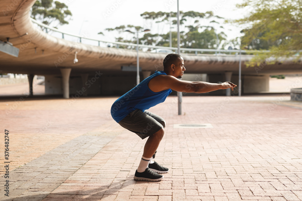 Black African American Man with prosthetic leg performing squat ...