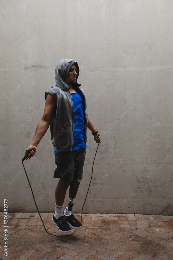 Black African American Man with prosthetic leg performing skipping rope ...