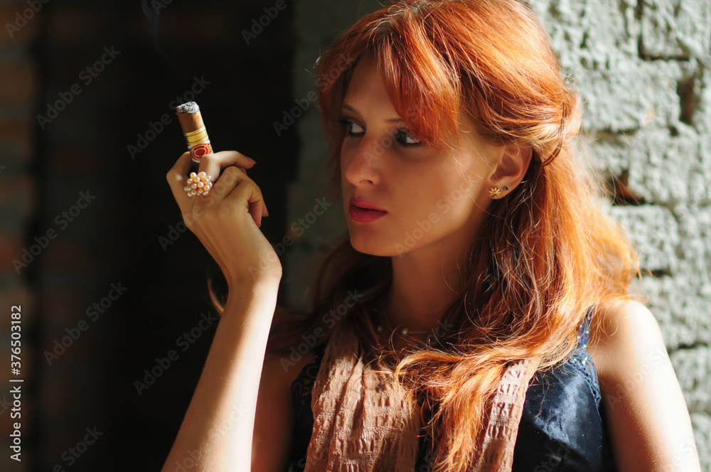 Elegant smoking woman. Portrait of a red-haired girl with a cigar Stock ...