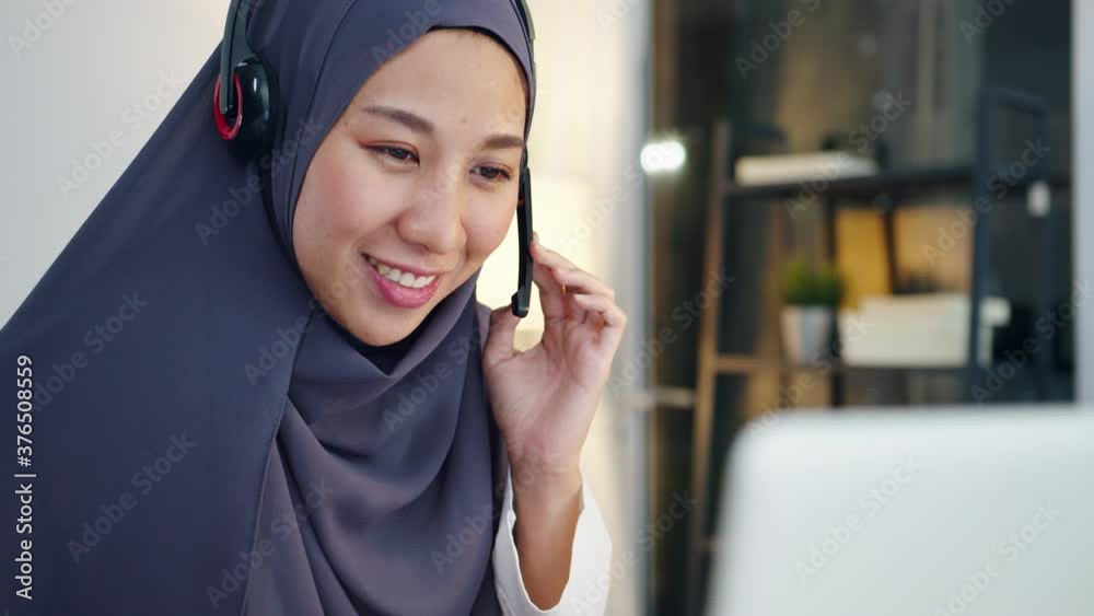 Asia muslim lady wear headphone watch webinar listen online course ...