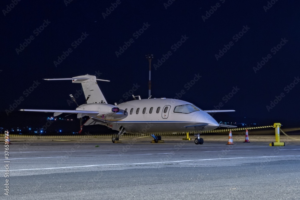Front side view of white business airplane with twin turboprop engines ...
