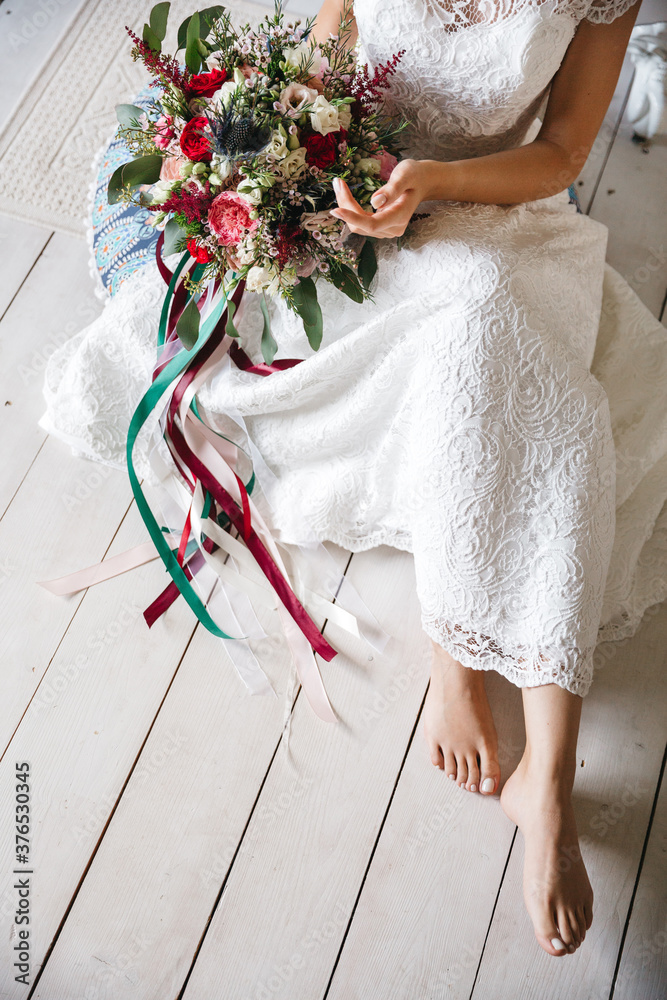 Top view of bride barefoot legs with colorful wedding bouquet on white ...