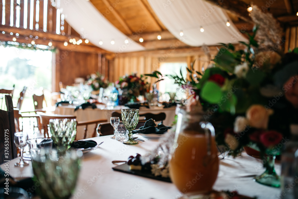 Side view of table serving with decorative floral composition and ...