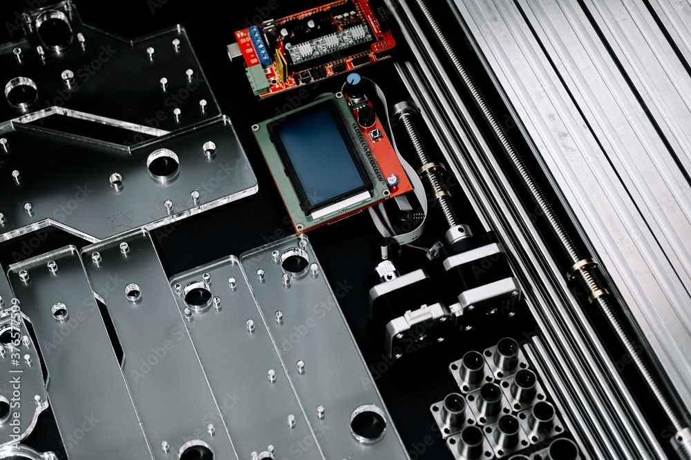 a set of parts for a laser machine on a black background, silver ...