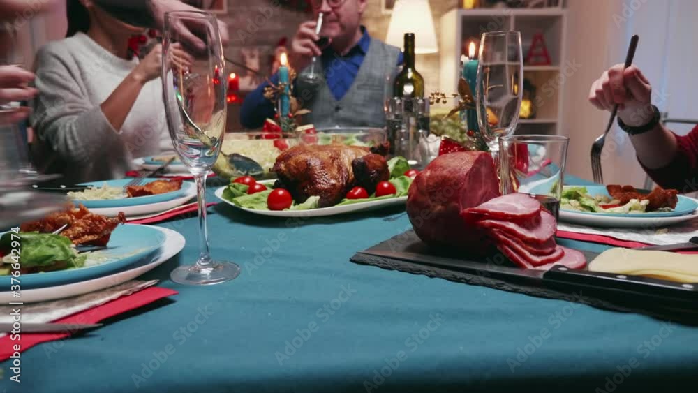 Father slicing chicken at christmas celebration for his family ...
