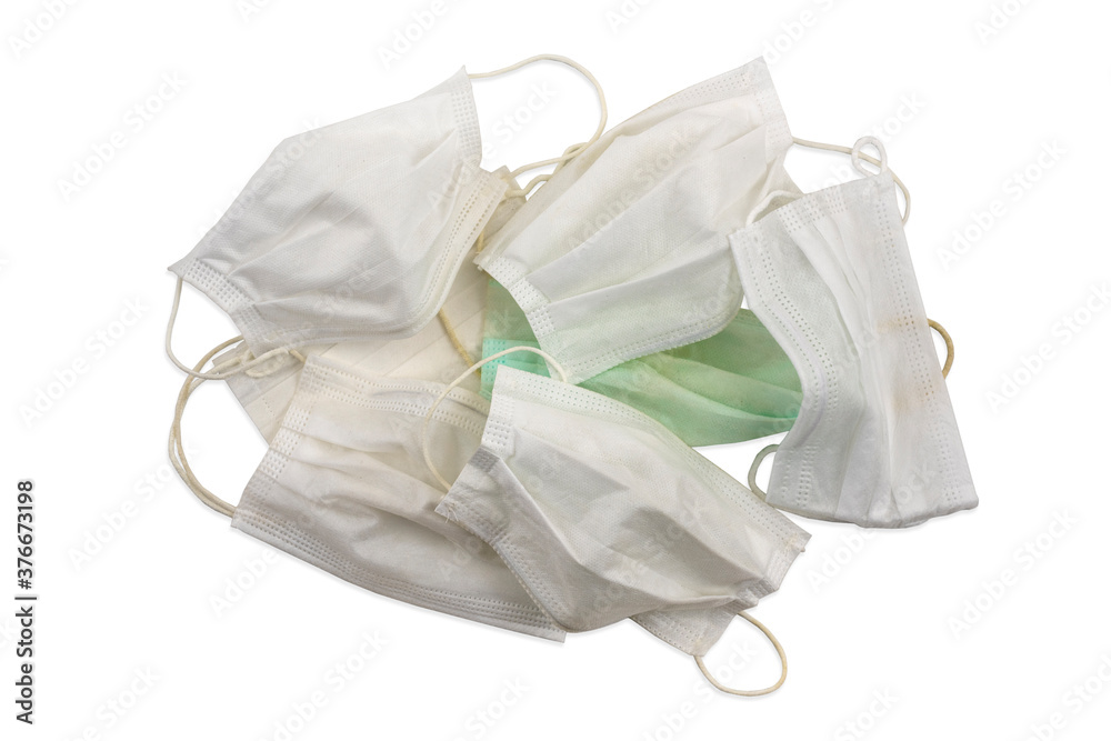 Used medical face masks isolated on white background. New normal after ...