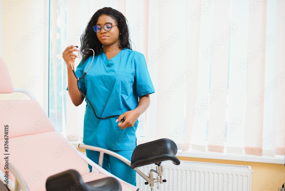Professional female doctor on blurred consulting room background ...