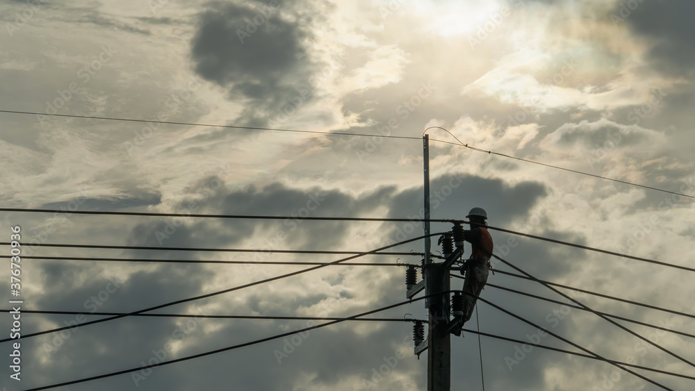 Electrician worker climbing electric power pole to repair the damaged ...