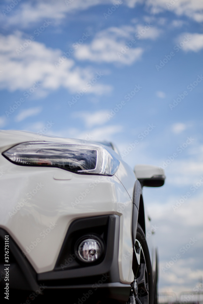Bumper / Front of the white sports car.The car is on the road.Element ...