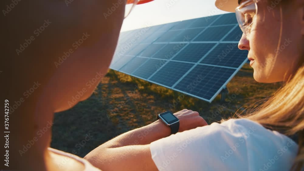Two male and female industrial experts using futuristic smartwatch ...