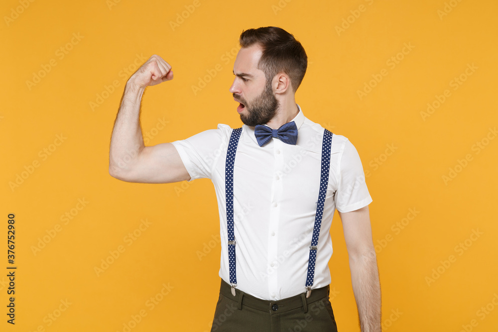 Shocked puzzled strong young bearded man 20s wearing white shirt bow ...