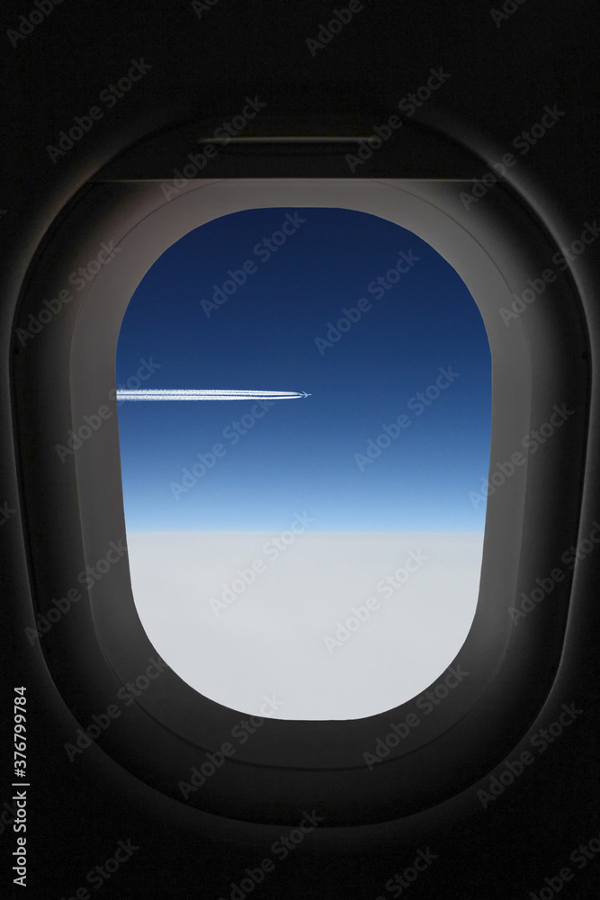 View through airplane window, porthole of an airplane that flys above ...