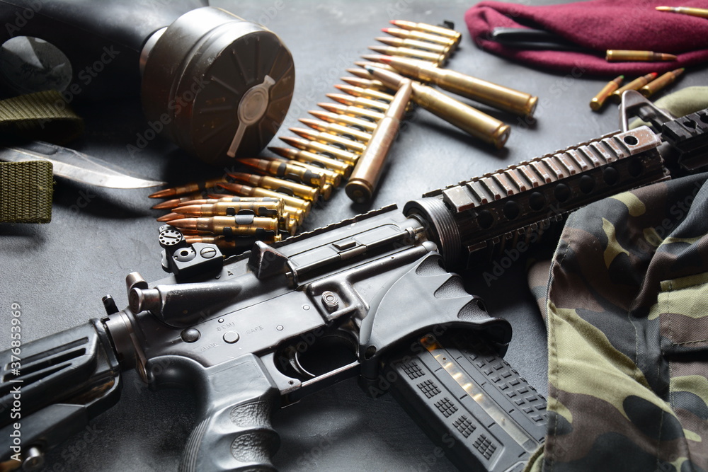 Assault rifle (M4A1) with ammunition on camouflage uniform,and military ...