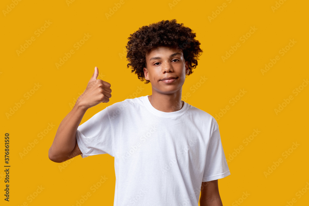 Like gesture. Social pressure. Confused black teen boy showing thumb up ...