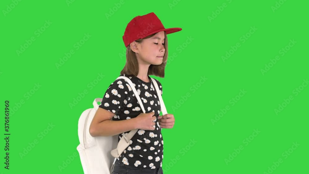 Happy Asian schoolgirl with backpack walking on a Green Screen, Chroma ...