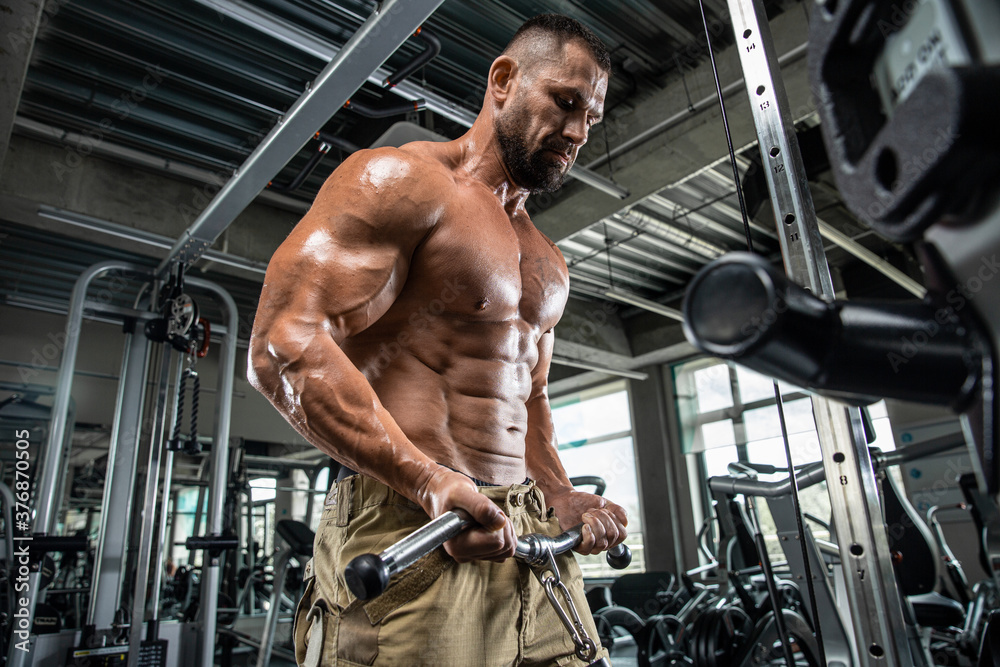 Attractive tall muscular bodybuilder doing heavy deadlifts in moder ...