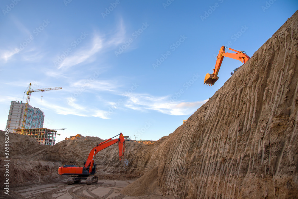 Digging the pit foundation a hole with excavator. Earthwork in ...