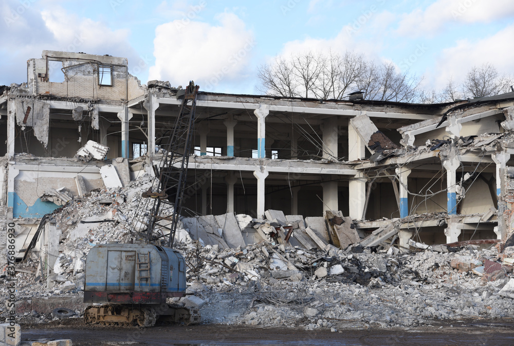 Crawler crane with a heavy metal wrecking ball on a steel cable at ...