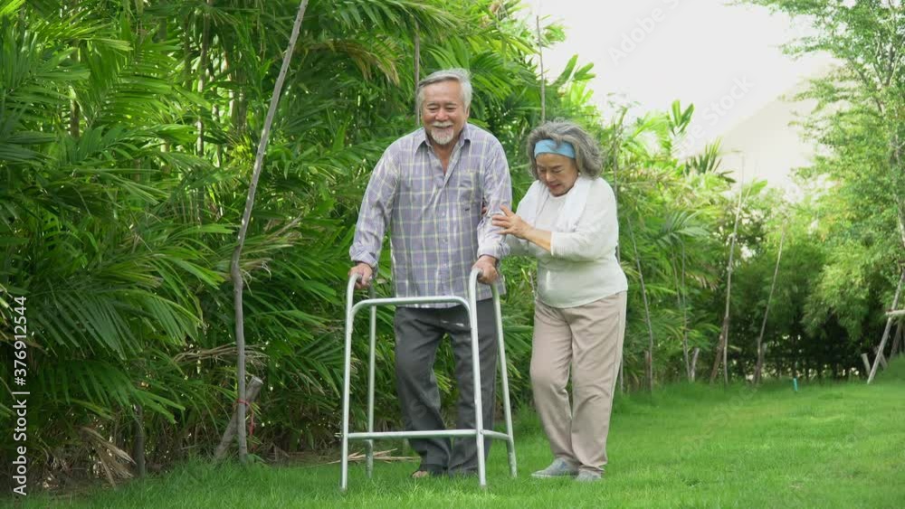 asian old couple walk with walker at home. senior man using a walker ...