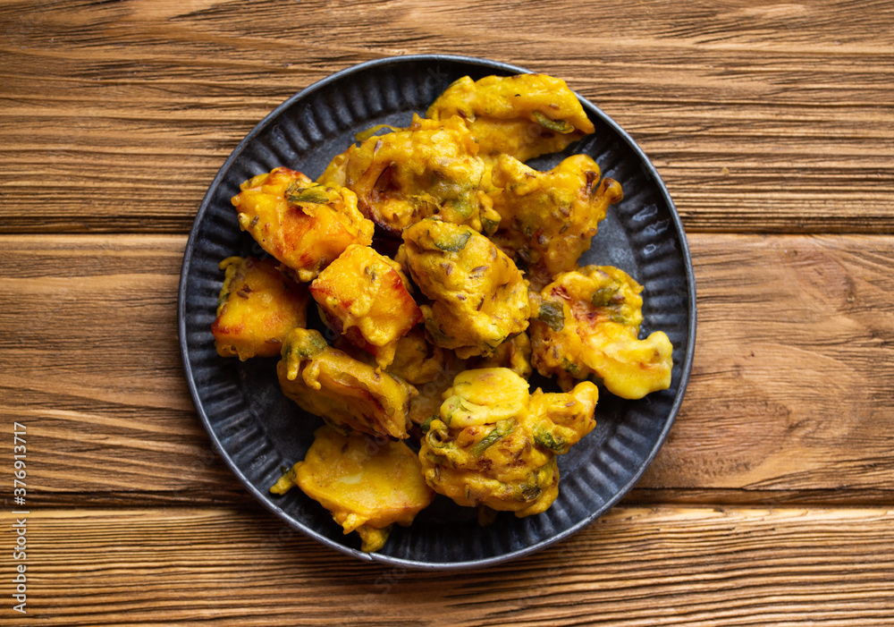Indian fried assorted pakoras on wooden rustic background. Traditional ...