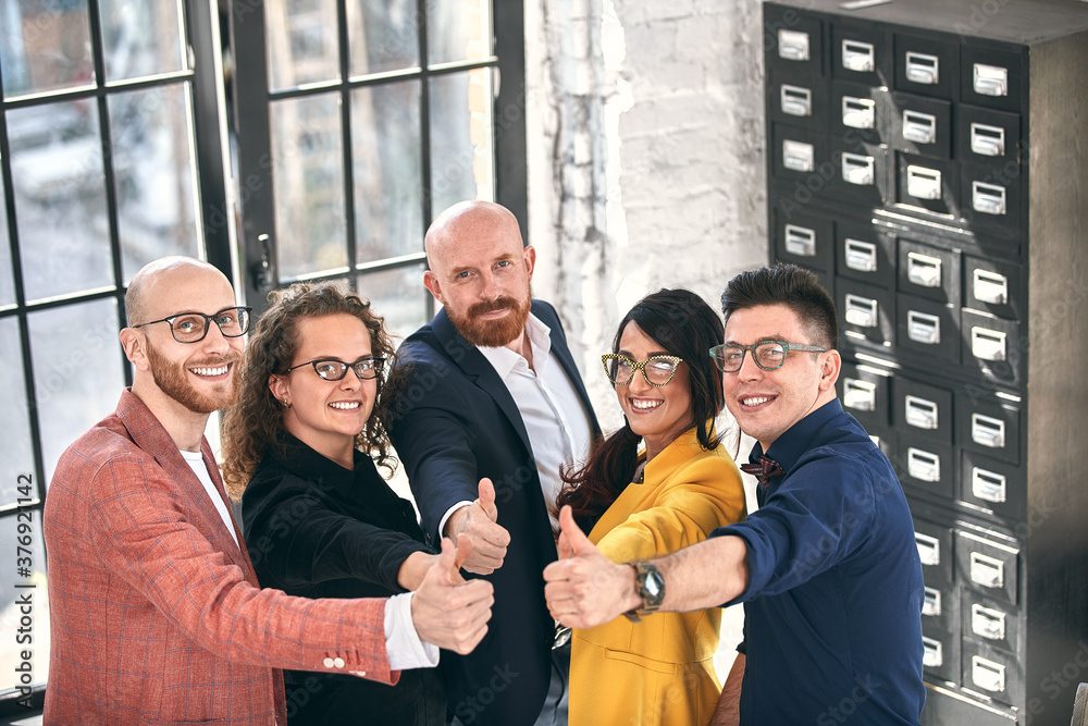 Group of joyful smiling happy people celebrate win with arms up ...