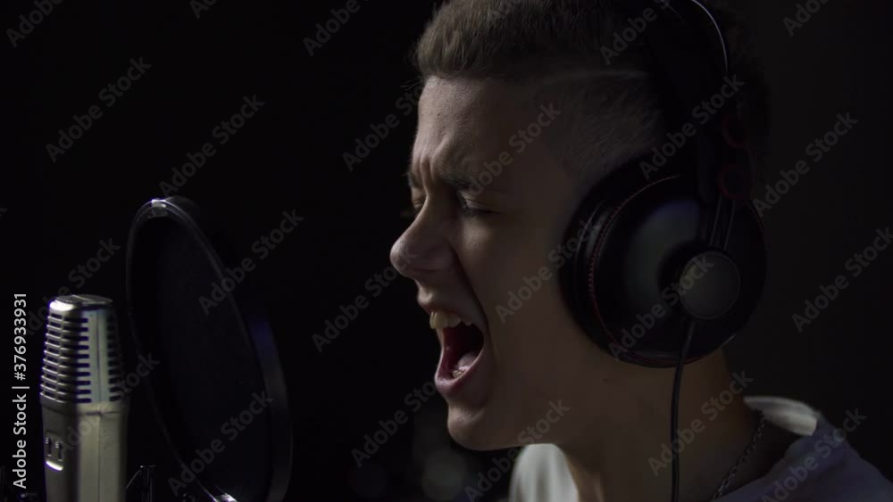 boy singing into studio microphone Stock Video | Adobe Stock