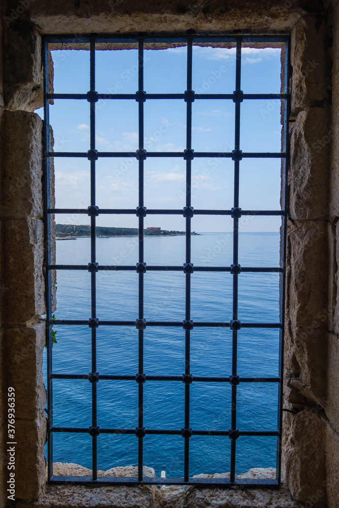 View onto Mediterranean sea & its coastline through grate window of ...