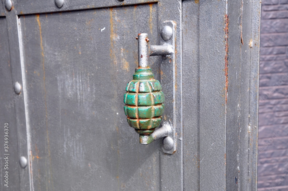 door knob doorhandle on the thick metall door looks like grenade weapon ...