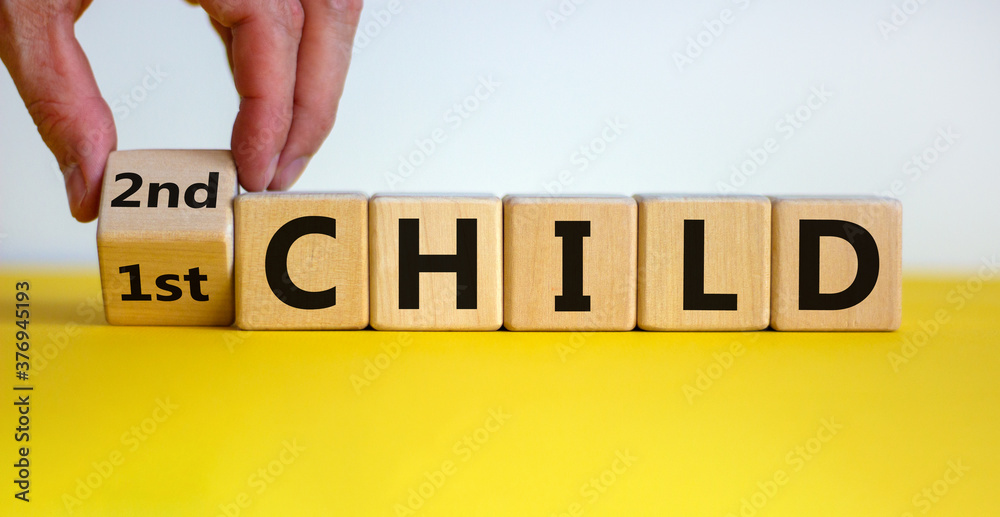 Expecting a second child. Hand turns a cube and changes the expression ...