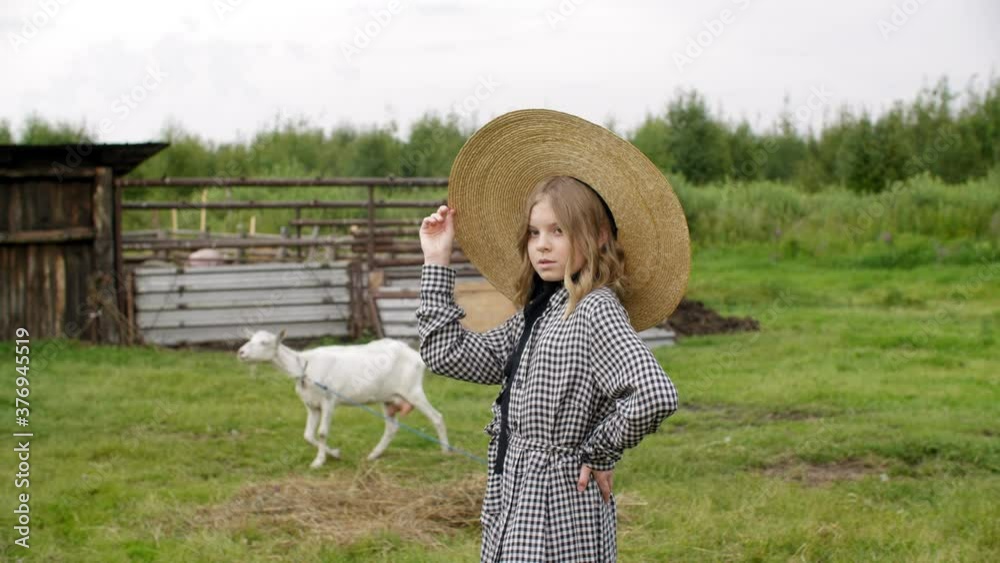Adorable teenage girl in hat posing on rural farm. Portrait of ...