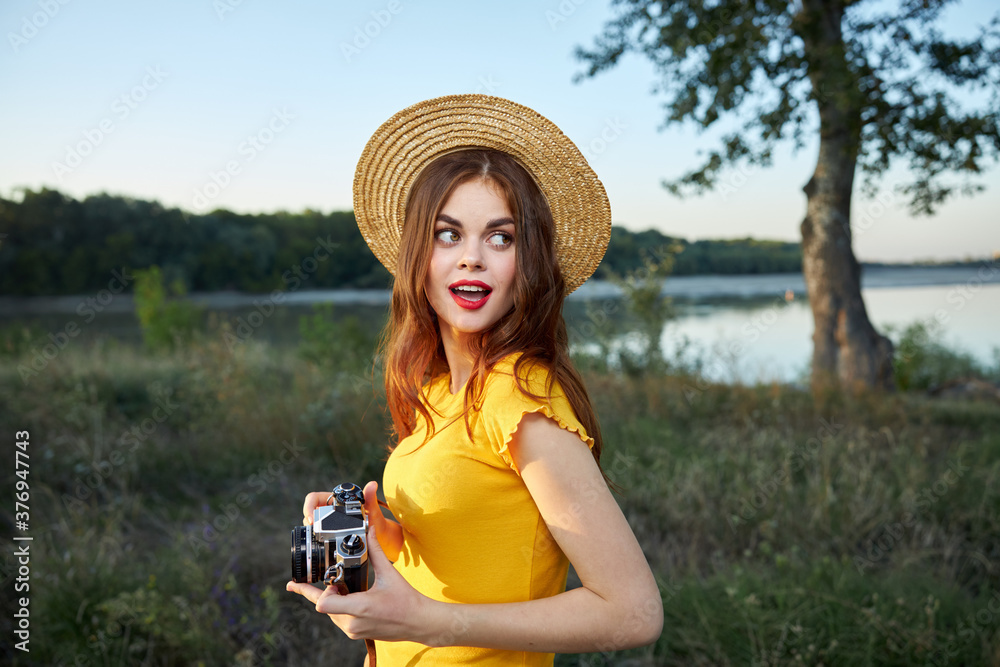 woman with a camera looking this way red lips hat travel leisure nature ...