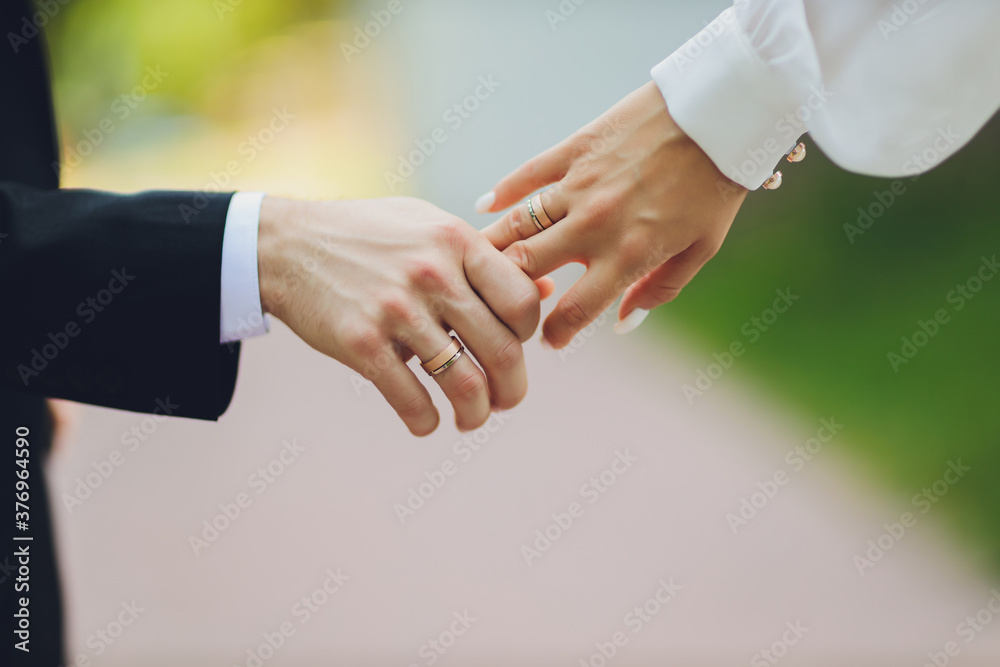 The groom holds the bride's hand at the wedding ceremony. Hold hands ...