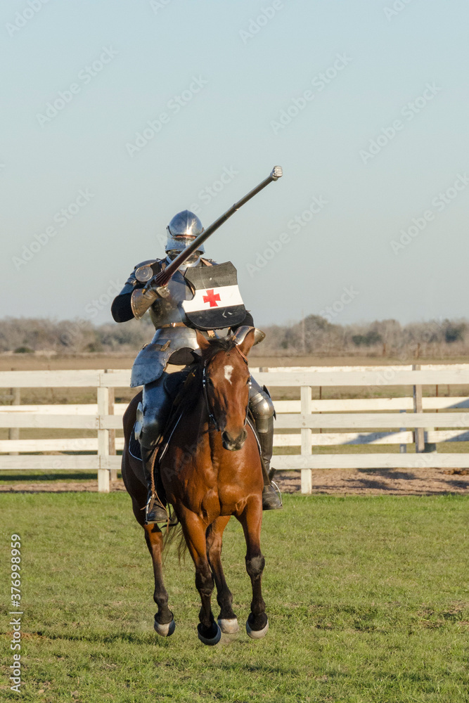 Knight riding horse with lance and shield to joust Stock Photo | Adobe ...