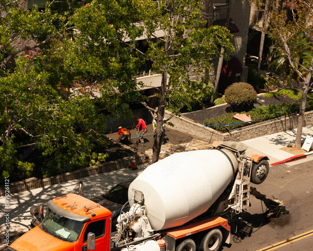 Top view of laying cement using cement mixer truck and hand tools for ...