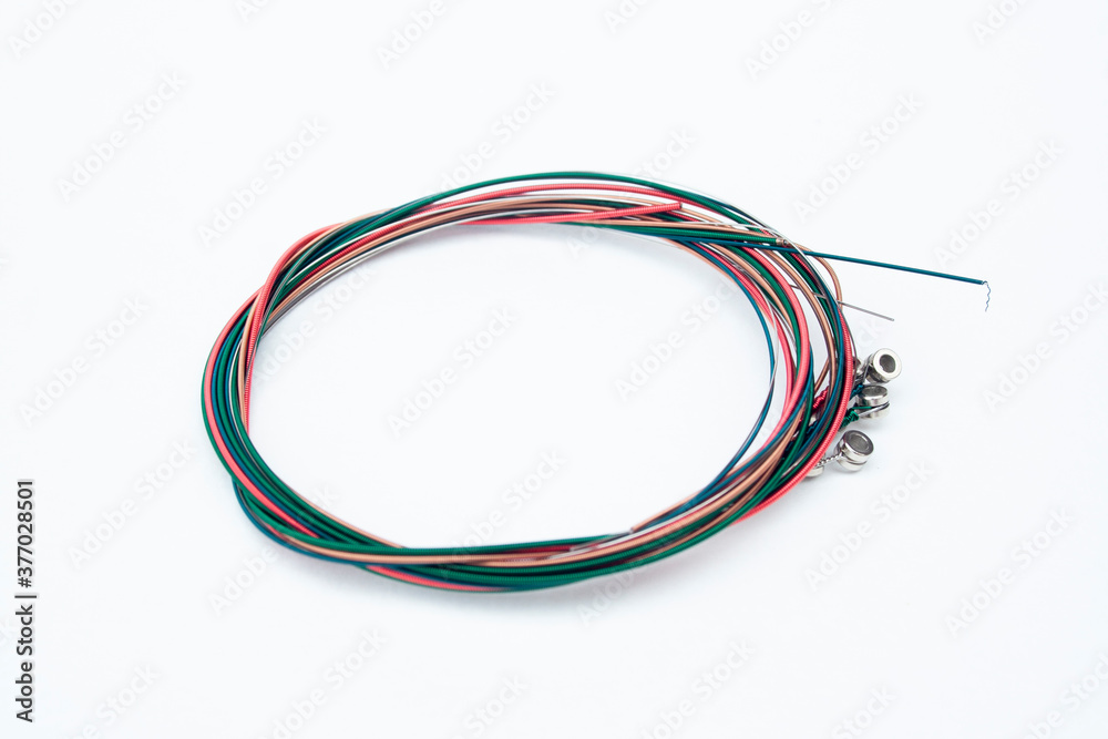 Metal strings for an acoustic guitar isolated on white background ...