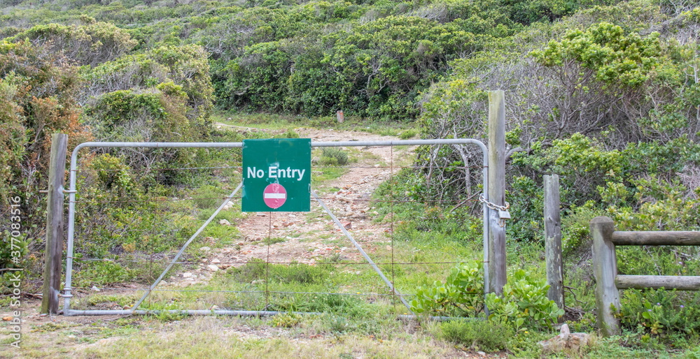 A locked gate with a no entry sign in a broken fence concept fail Stock ...