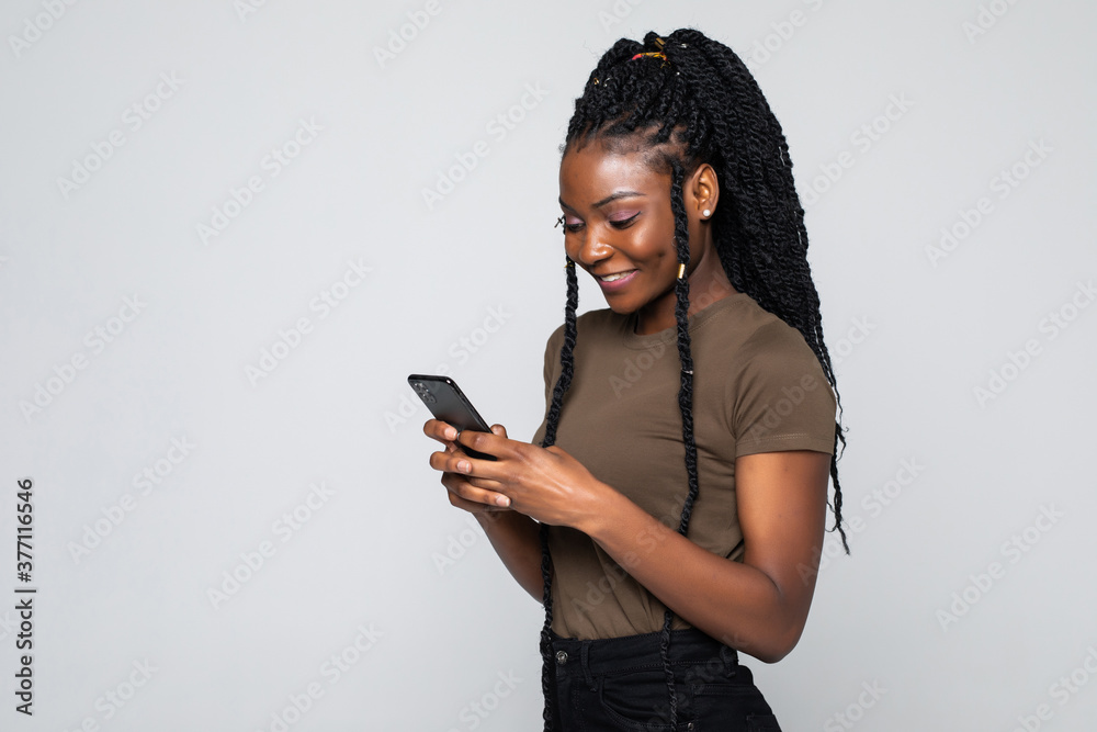 Happy Young African Woman Casually Dressed Holding Mobile Phone