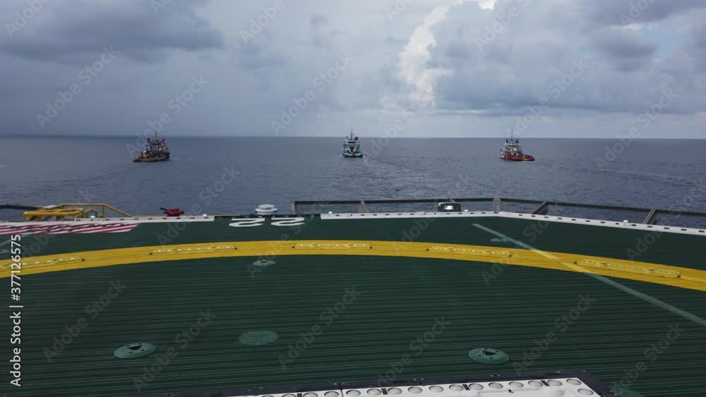 Offshore supply vessel tow a jack up oil drilling rig in the middle of ...