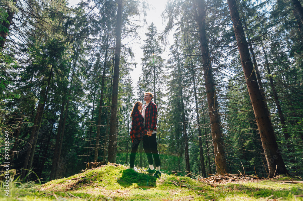 Bbeautiful couple of hipsters in love stands in a beautiful untouched ...