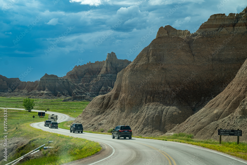 Cars travel the Badlands Loop Road in Badlands National Park, as a ...