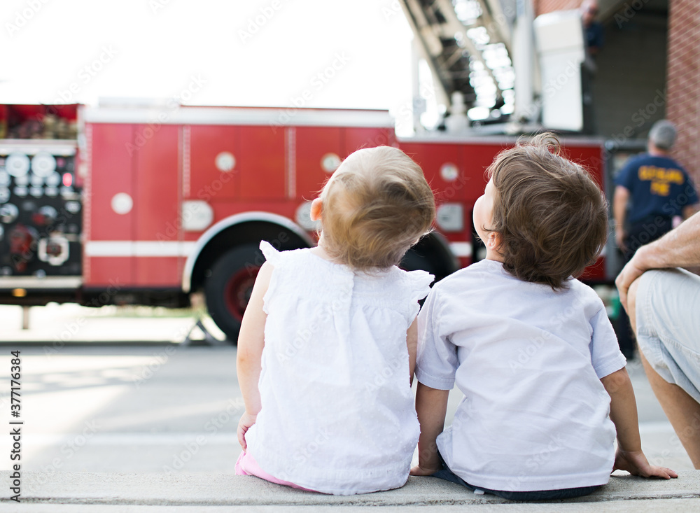 kids look at fire truck ladder Stock Photo | Adobe Stock