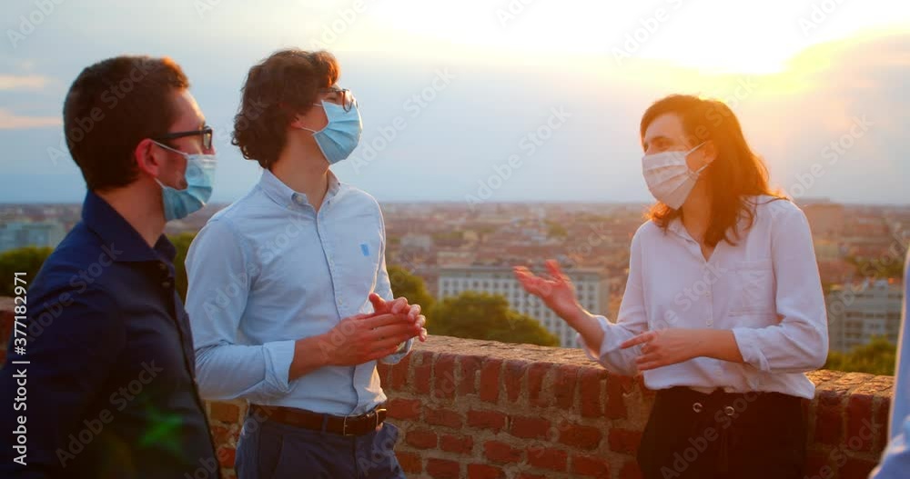 A group of friends talking during a party, people maintain social ...