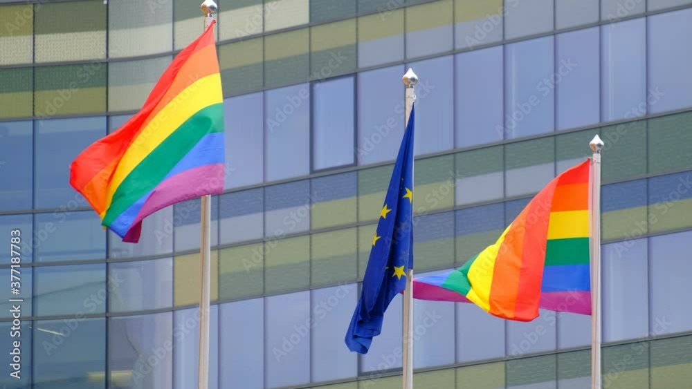 The Pride flags and European Union flag on white flagpoles against the ...