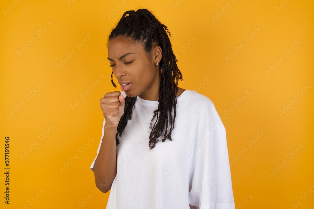 Young dark skinned woman with braids hair wearing white t-shirt over ...