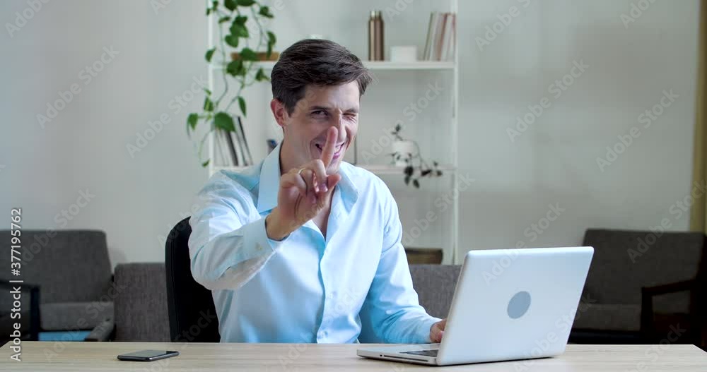 Young attractive man typing on laptop, shopping online, waving negative ...