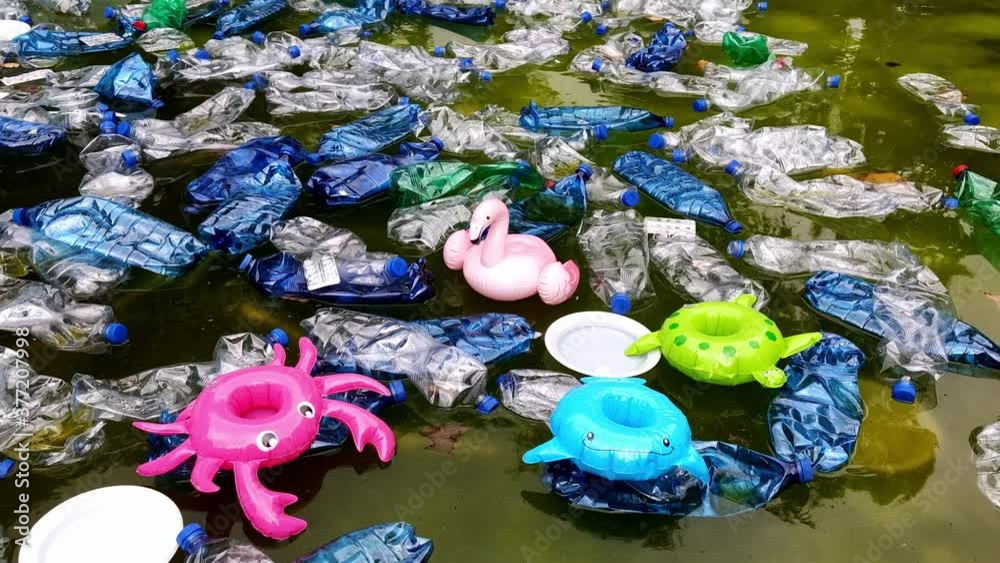 pollution of the environment. plastic bottles in water and inflatable ...
